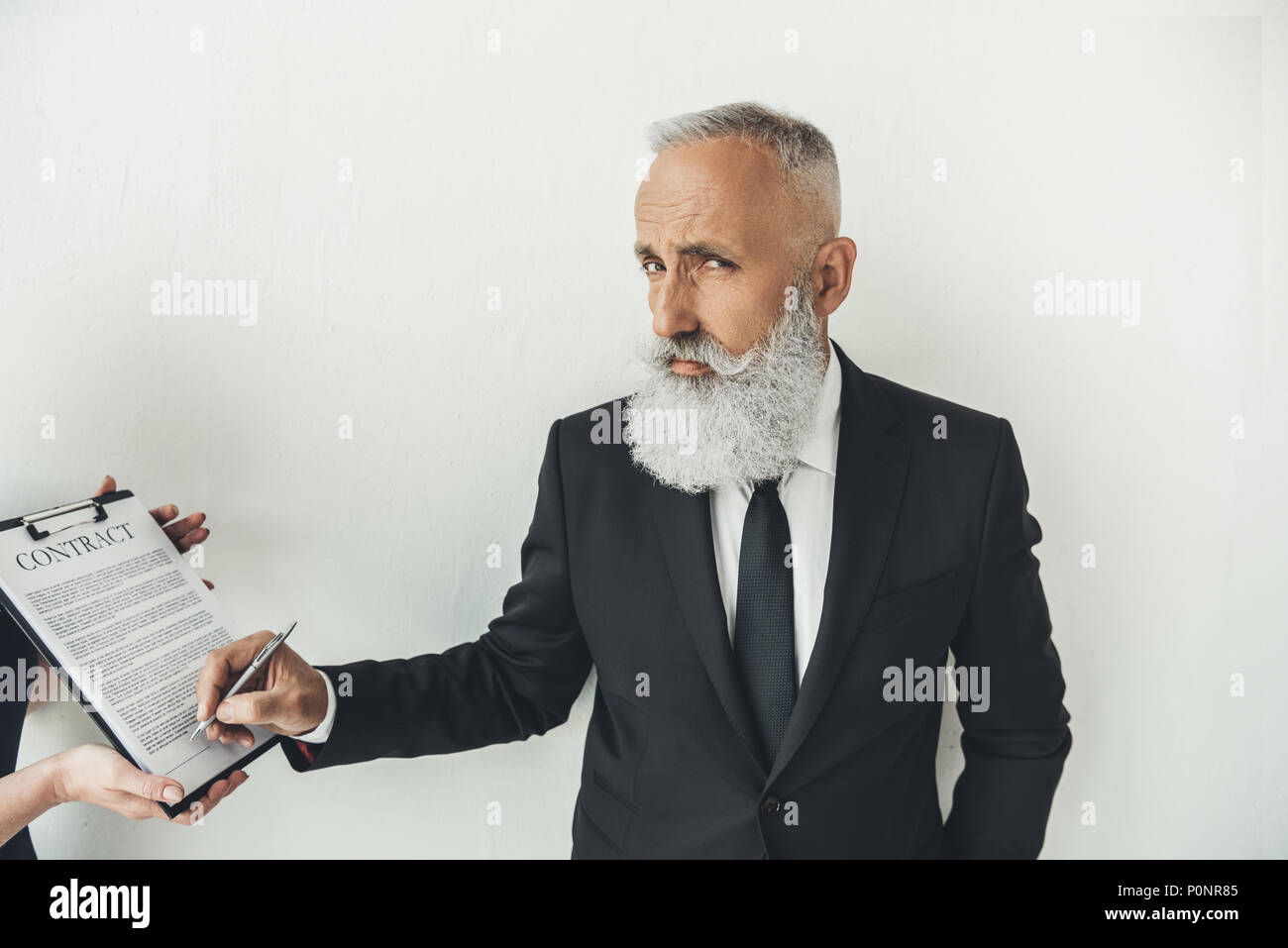senior businessman signing contract on white background Stock Photo - Alamy