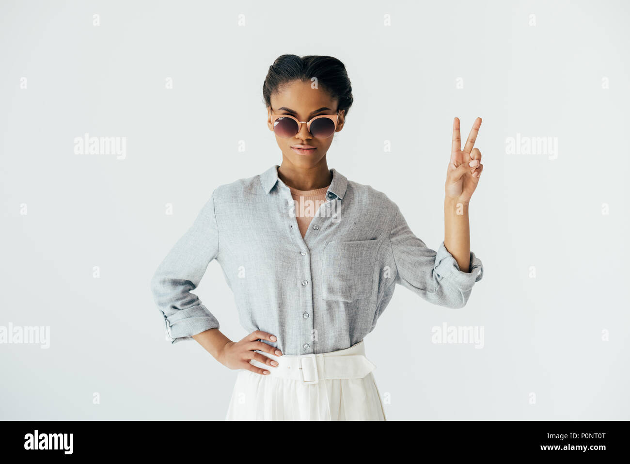 portrait of african american woman in sunglasses standing akimbo and ...