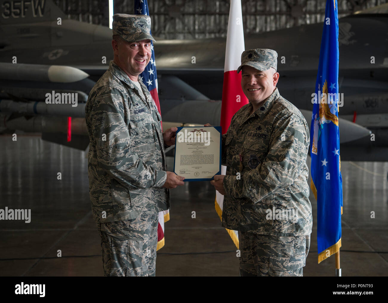 U.S. Air Force Col. Thomas Schramel, the 35th Maintenance Group commander, administers a change ...