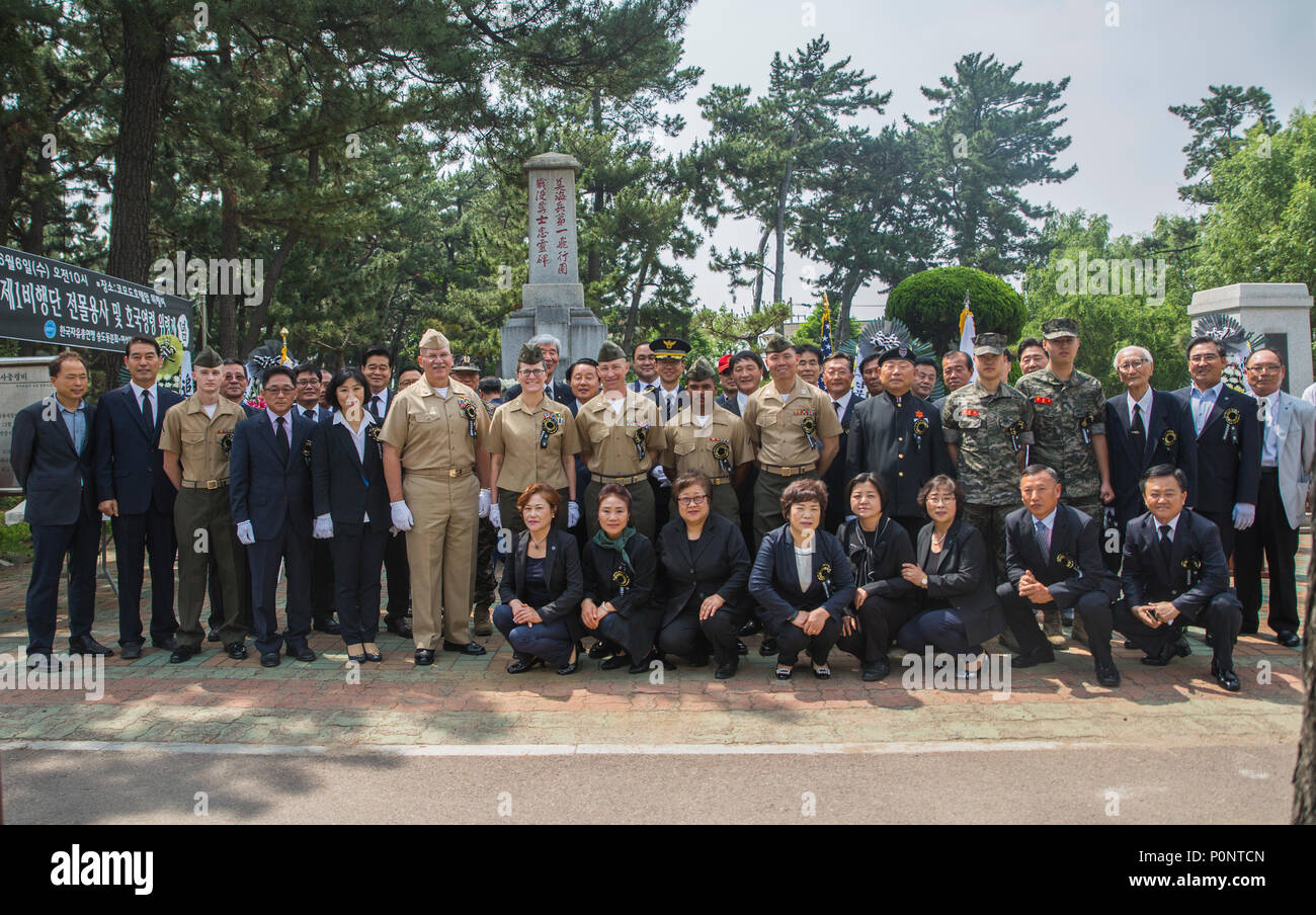 Guests of a memorial ceremony pose for a photo at Pohang City Battle ...