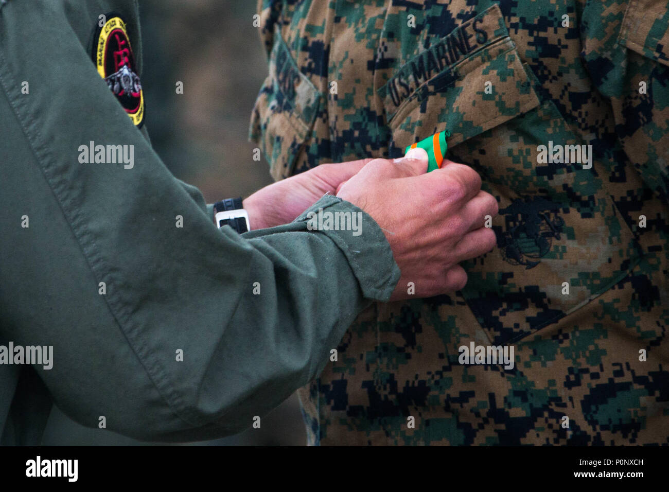 U.S. Marine Corps Lt. Col. Steven M. Schreiber, left, pins Lance Cpl ...