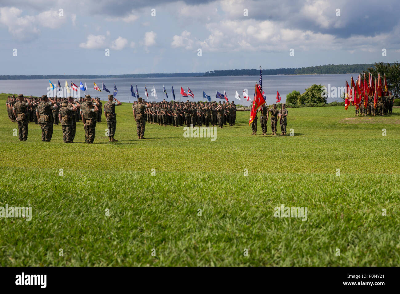 U.S. Marines and Sailors with 2nd Marine Logistics Group salute during ...