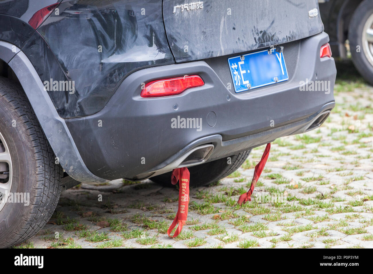 Suzhou, Jiangsu, China. Chinese Custom: Tying Colored Fabric on Bumper ...