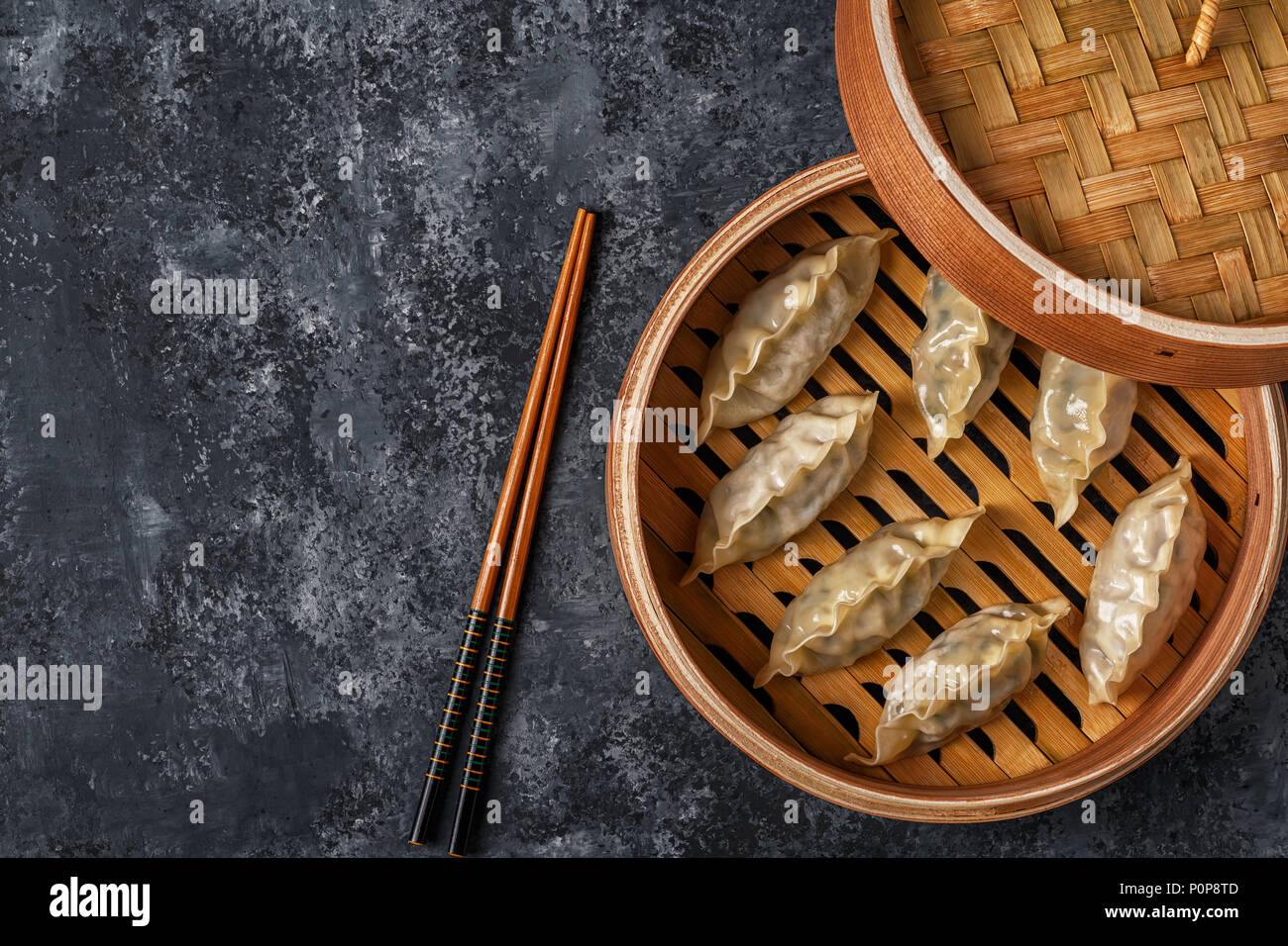 Fresh dumplings on a dark stone background. Asian cuisine, top view ...