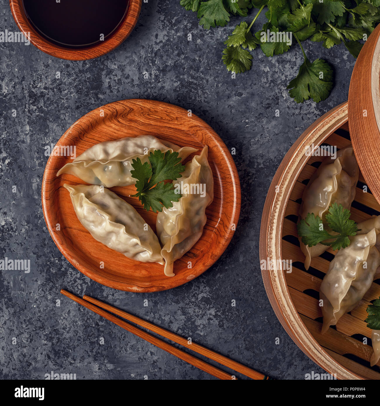 Fresh dumplings on a dark stone background. Asian cuisine, top view ...