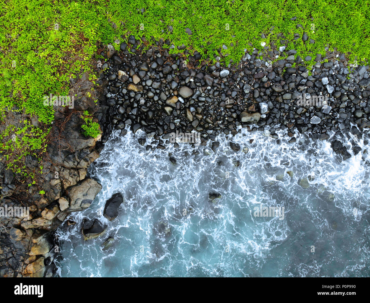 Aerial view of a black volcanic rock beach and ocean in Wailea, Maui ...