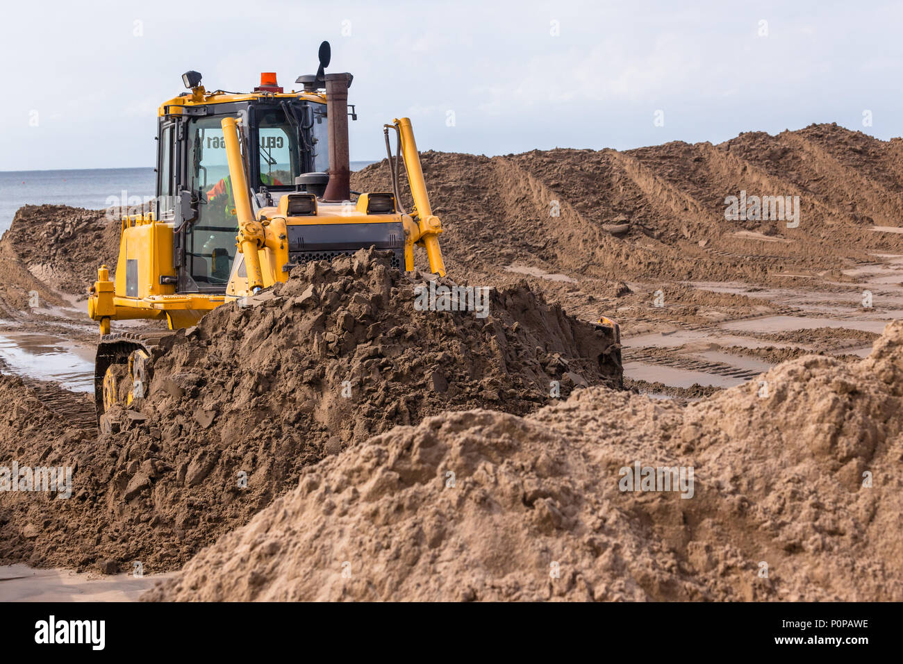 Earthworks construction heavy dozer machine pushing sand closeup photo ...