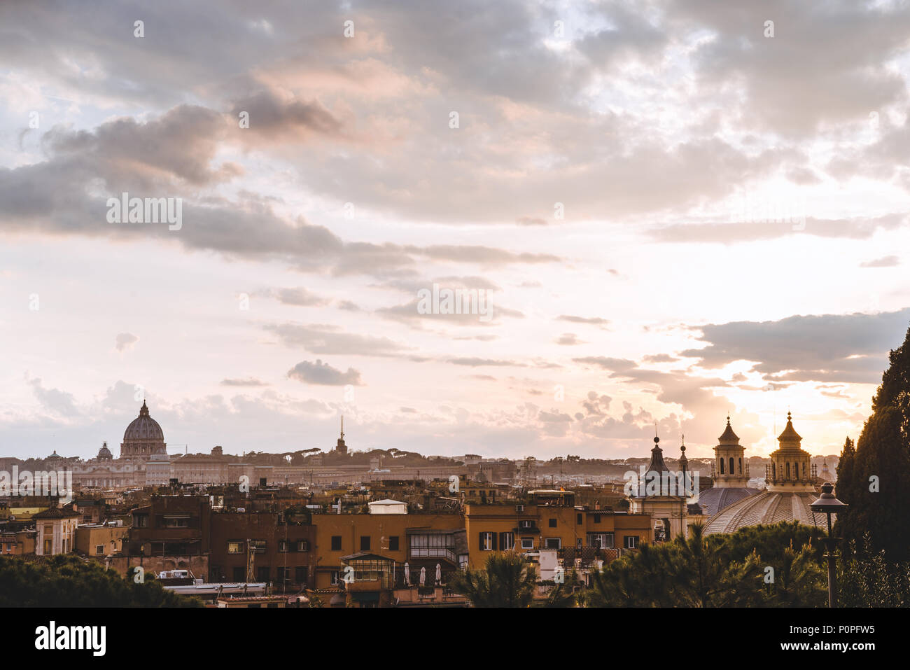 view of St Peters Basilica and cloudy sky during sunrise in Rome, Italy ...