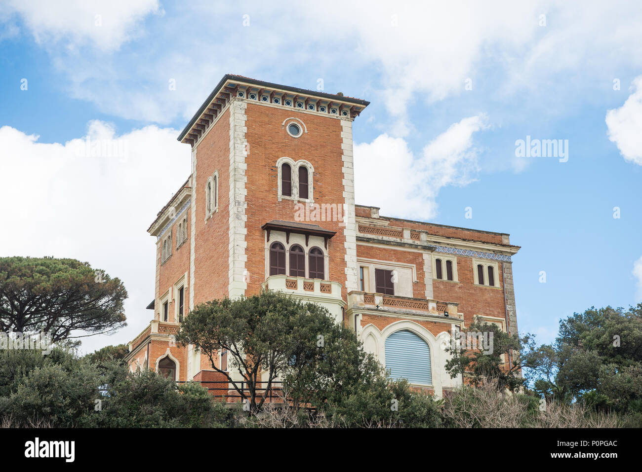 luxury building on surrounded with trees at Anzio, Italy Stock Photo ...