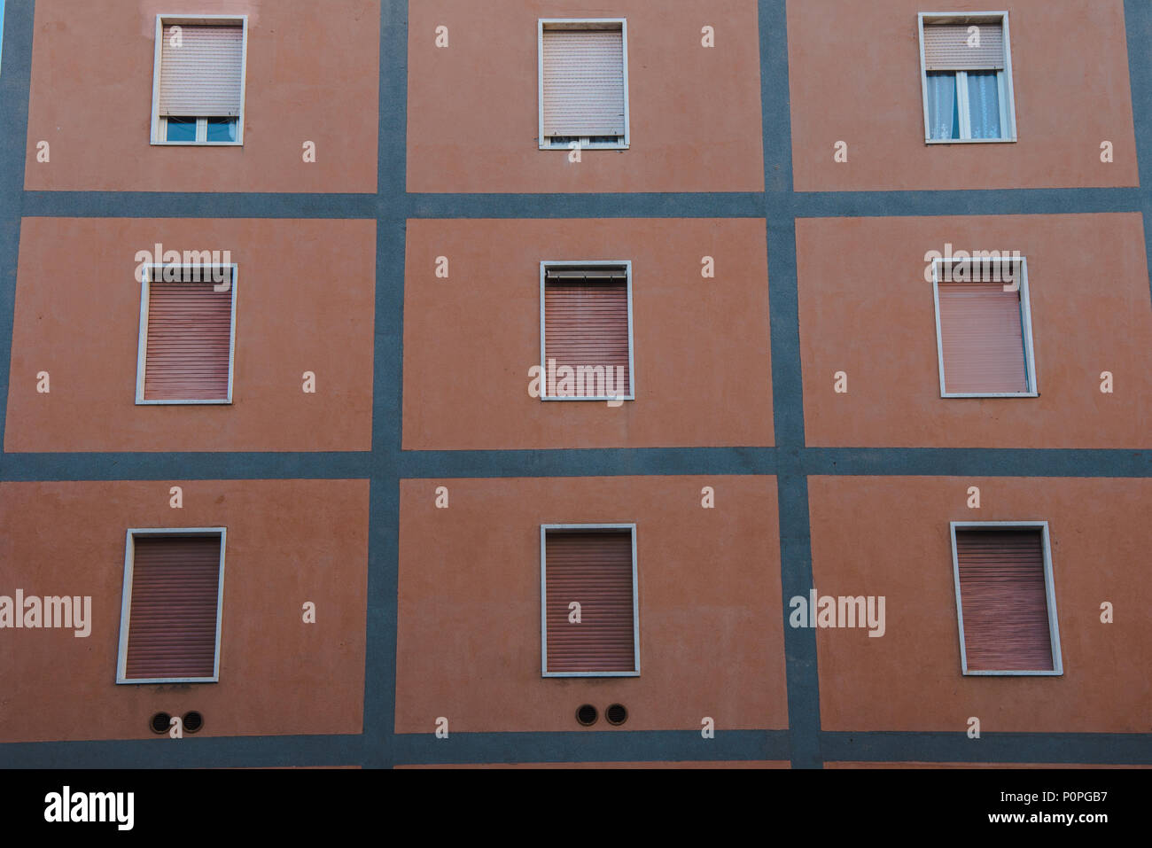 full frame shot of facade of european building with shuttered windows ...