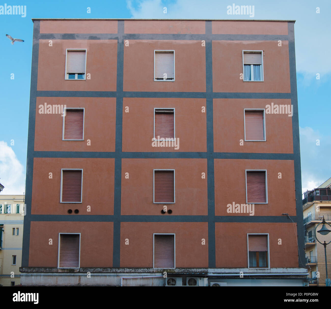 facade of european building with shuttered windows under blue sky ...