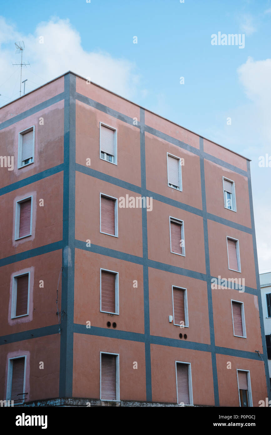 european building with shuttered windows under blue sky, Anzio, Italy ...
