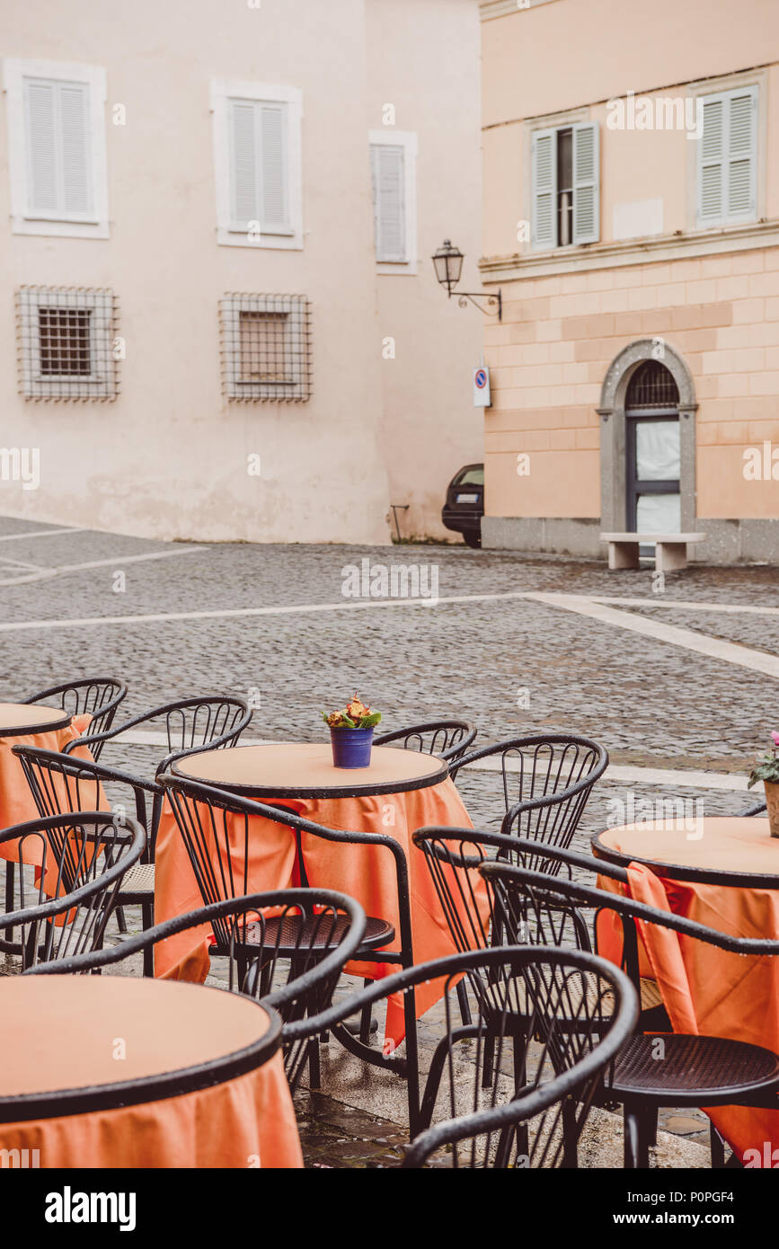 empty cafe tables on street in Castel Gandolfo, Rome suburb, Italy ...