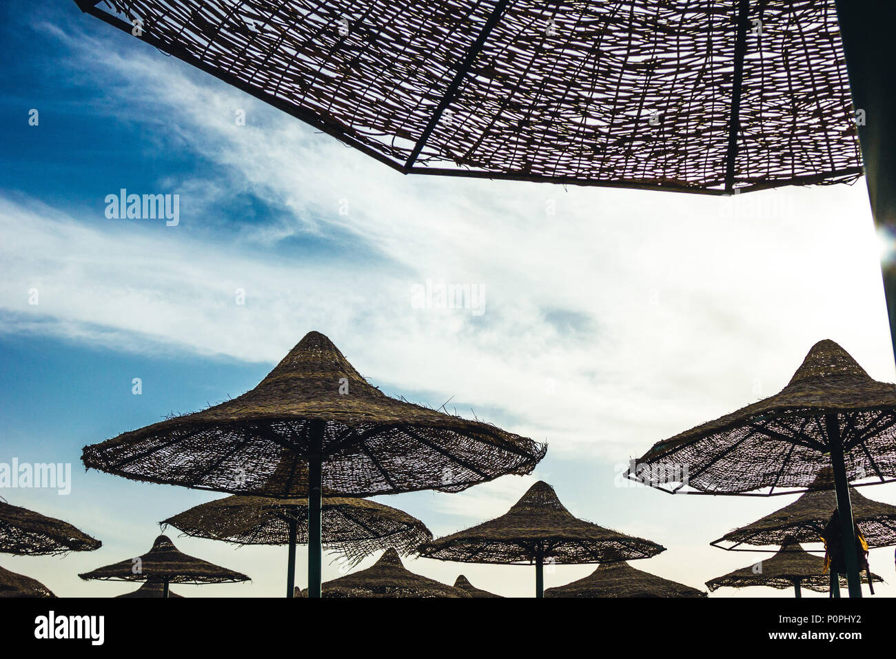 wicker umbrellas on beach at resort in Egypt Stock Photo - Alamy