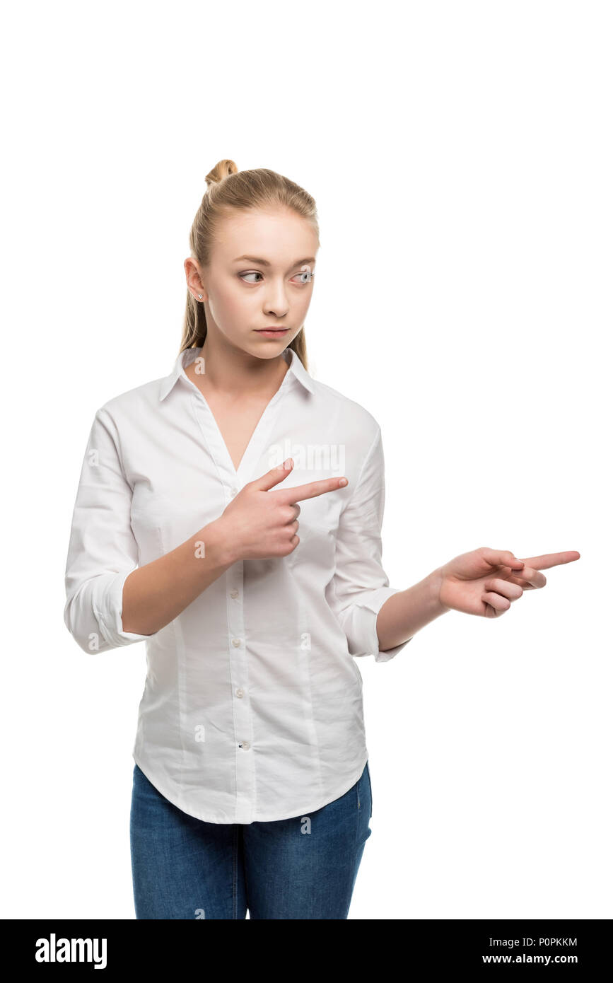 serious caucasian teenage girl looking and pointing away isolated on ...