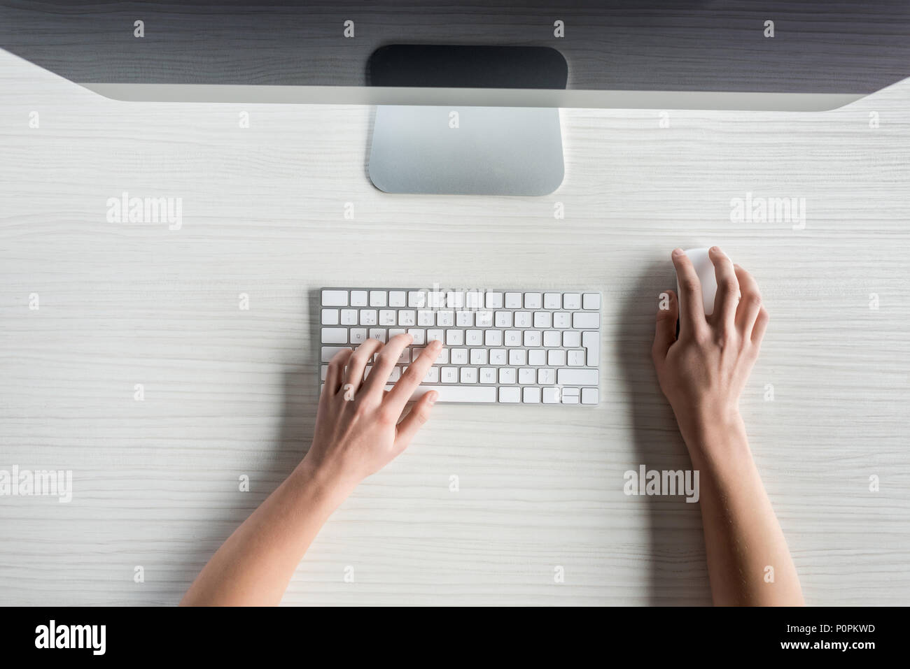 cropped shot of student typing on keyboard while working on computer ...