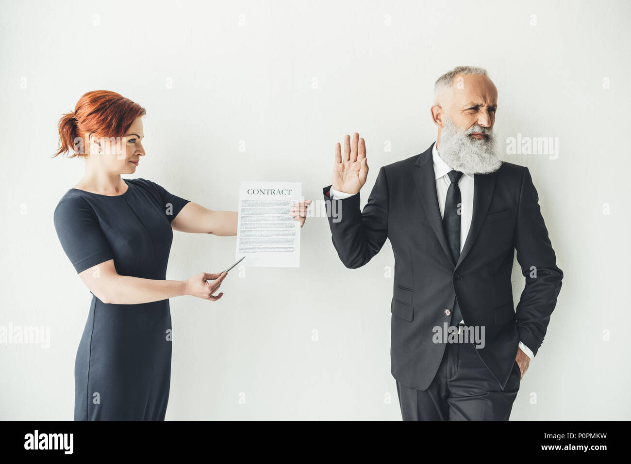 woman holding business contract and businessman refusing to sign it ...