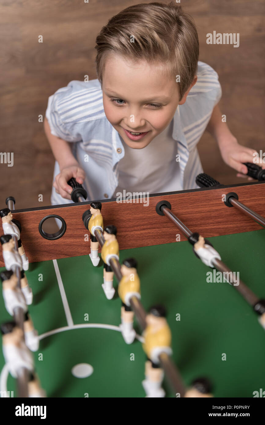 Close-up view boy playing table football Stock Photo - Alamy