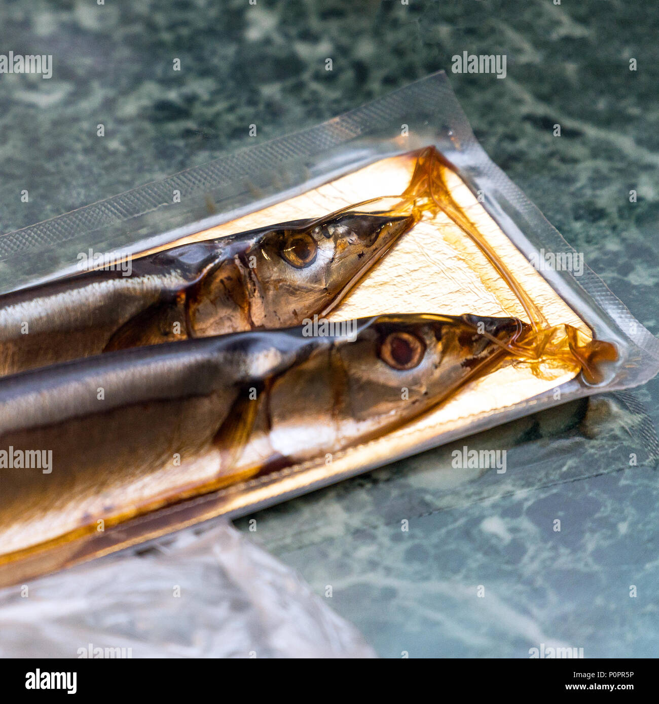 Sea fish saury in vacuum packaging Stock Photo - Alamy