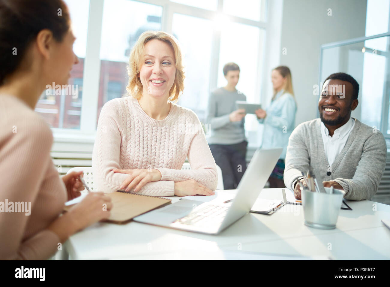 Cheerful team of white collar workers having fun together while wrapped ...