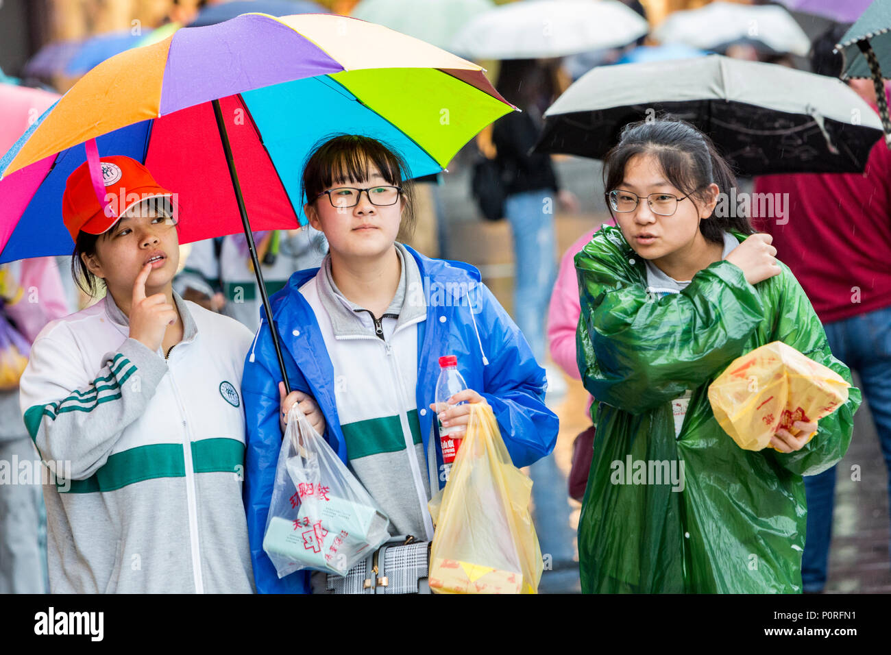 Nanjing, Jiangsu, China. Young Chinese Women Shopping in the Rain Stock ...