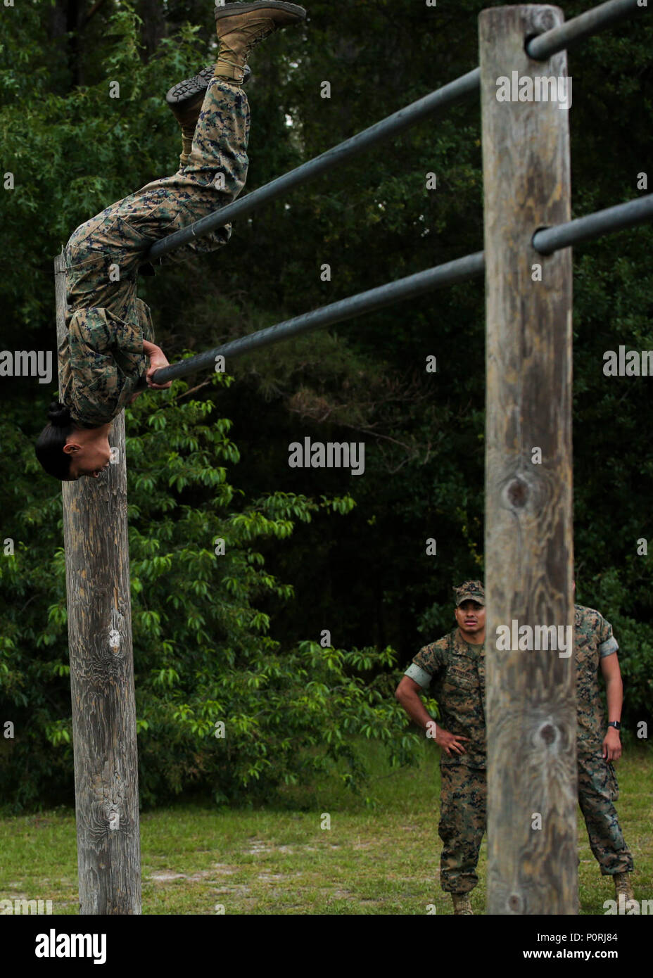A Marine maneuvers the obstacle course aboard Marine Corps Air Station ...
