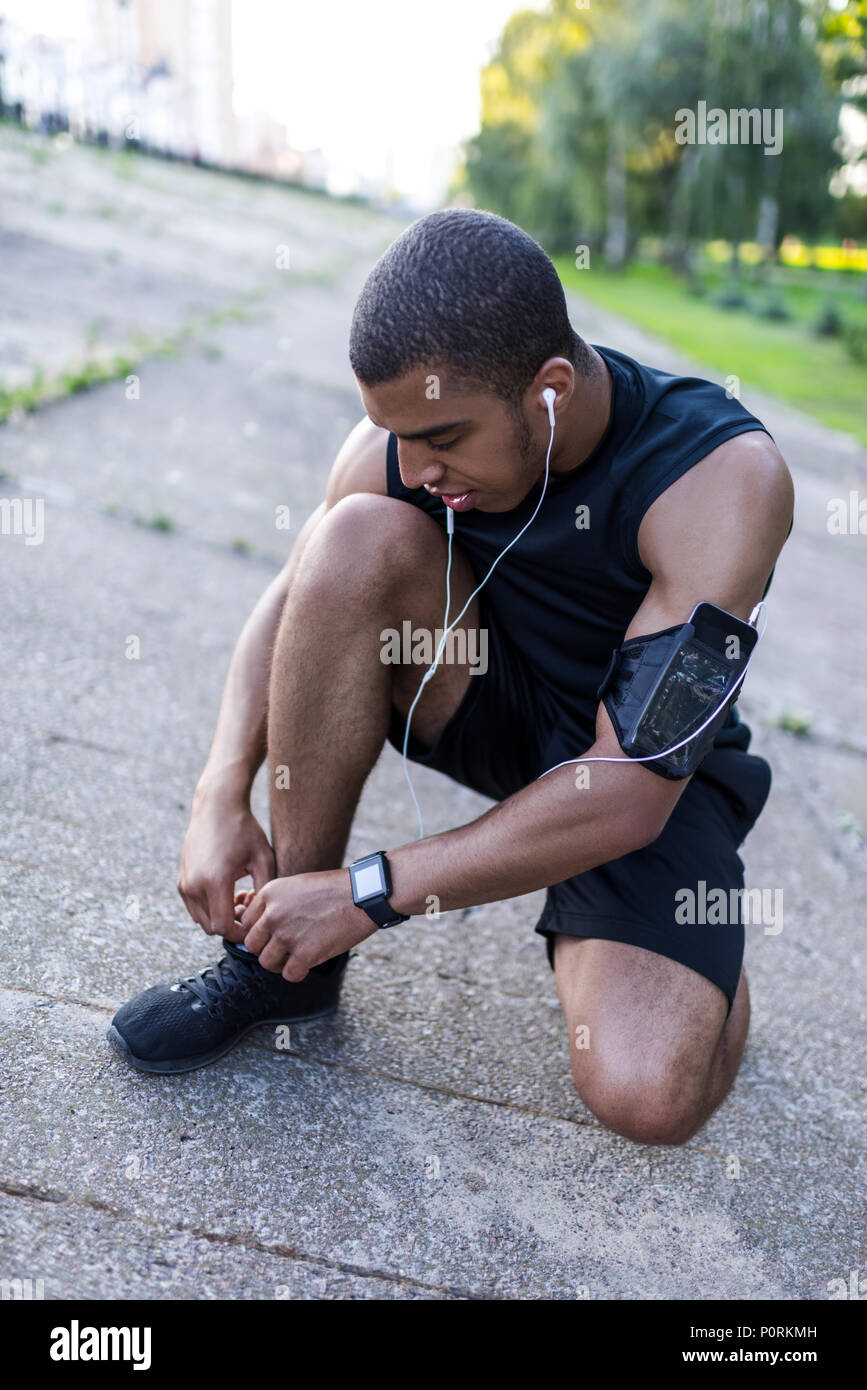 African american sportsman tying hi-res stock photography and images ...