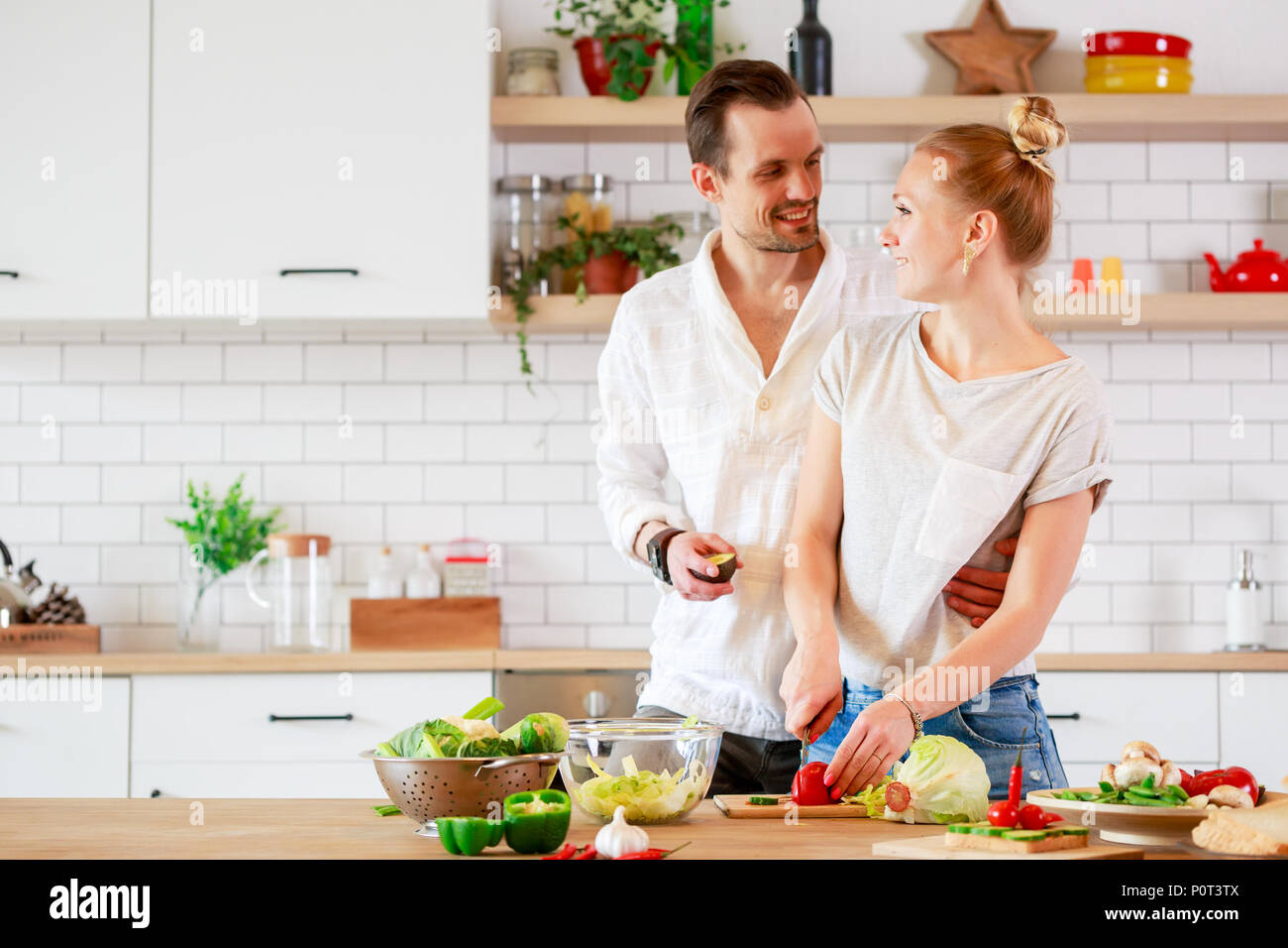 Image of beautiful loving couple cooking vegetables in kitchen Stock ...