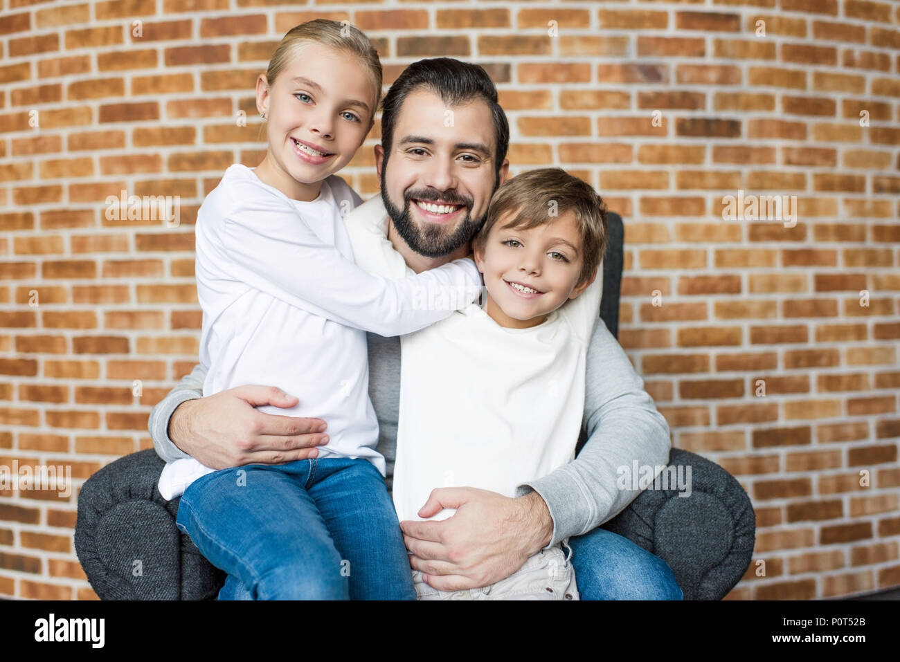portrait of cheerful siblings and father looking at camera Stock Photo ...