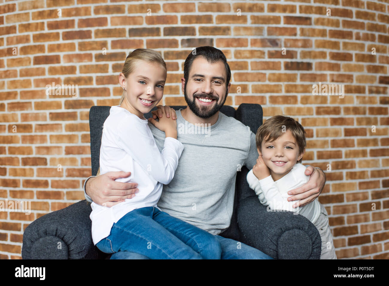 portrait of cheerful siblings and father looking at camera Stock Photo ...