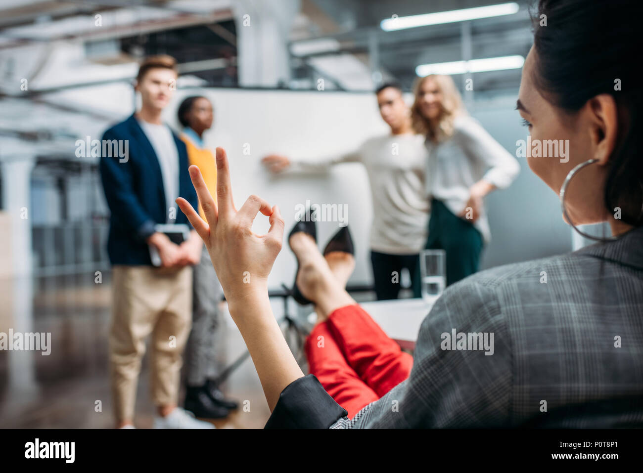 managers making presentation for lady boss while she showing okay sign ...