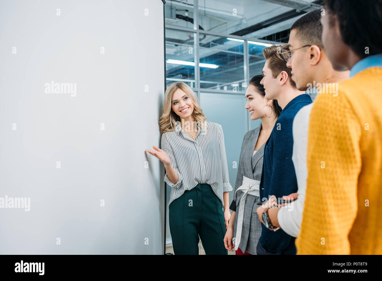 young woman making presentation for group of business partners Stock ...