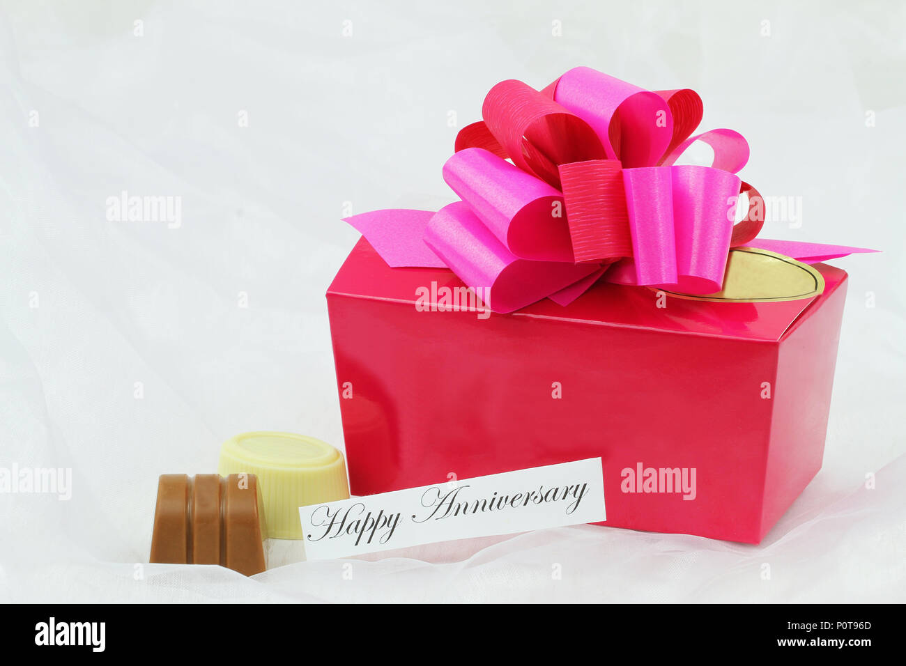 Happy Anniversary card with pink box of chocolates on white satin Stock ...
