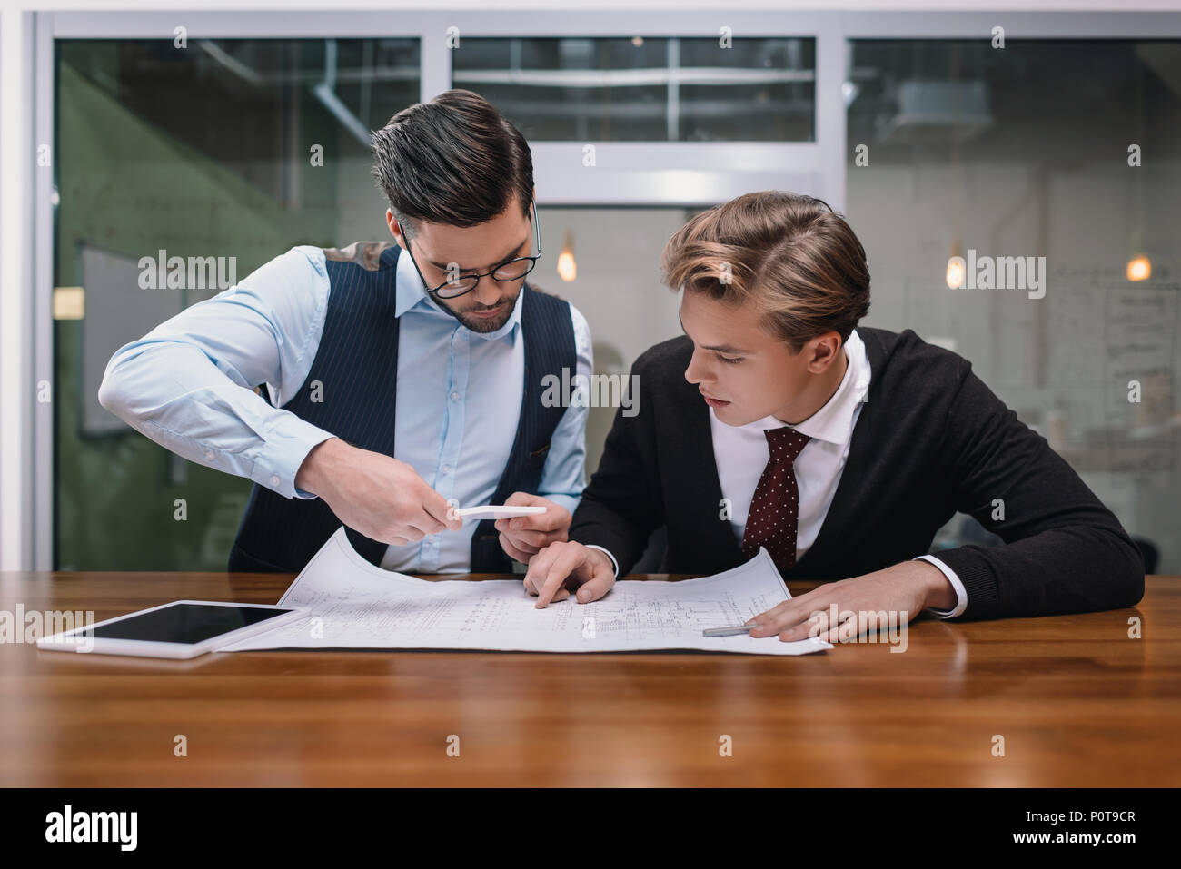 businessmen working together with blueprint in office Stock Photo - Alamy