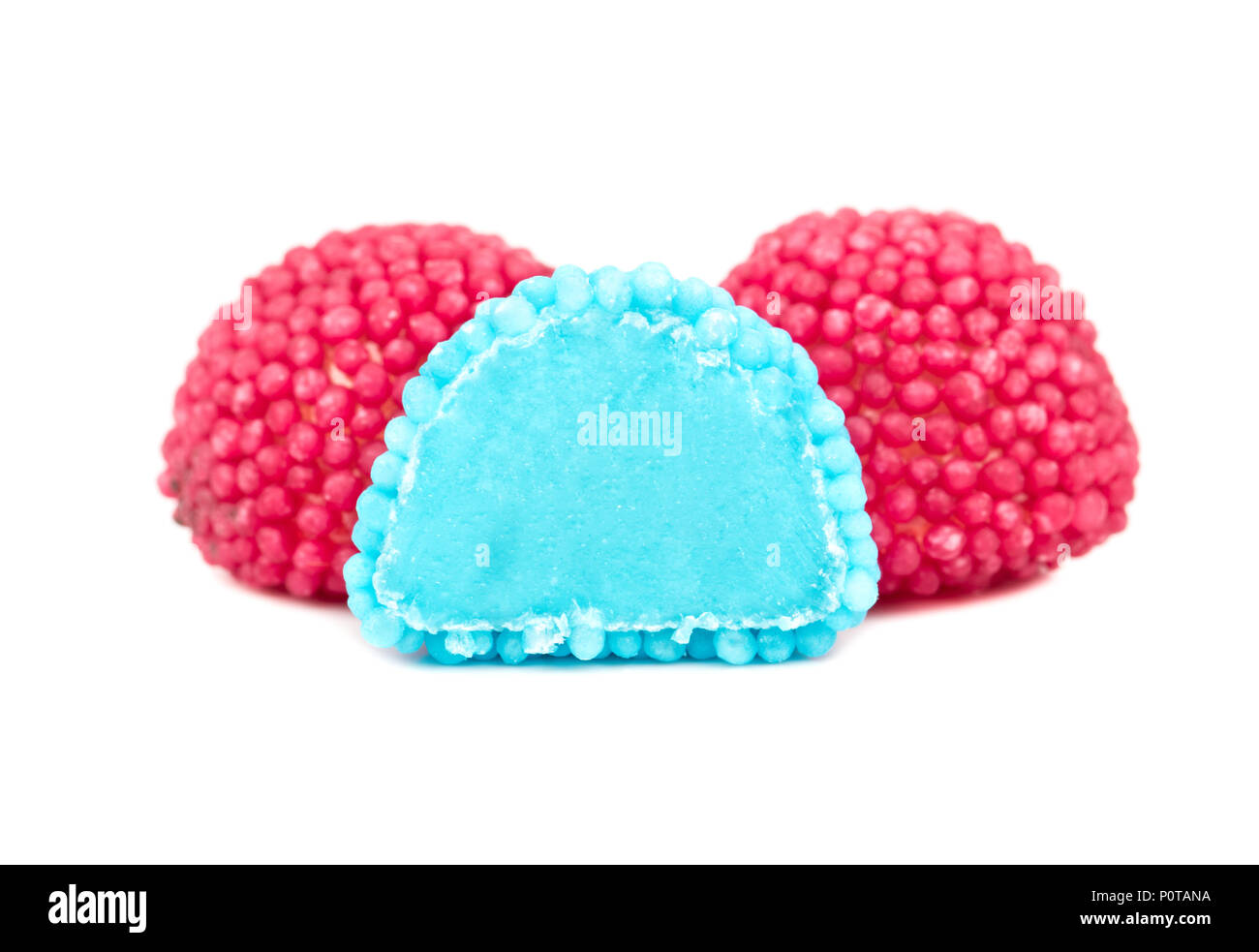Red berry jelly candy with blue half on a white background Stock Photo ...