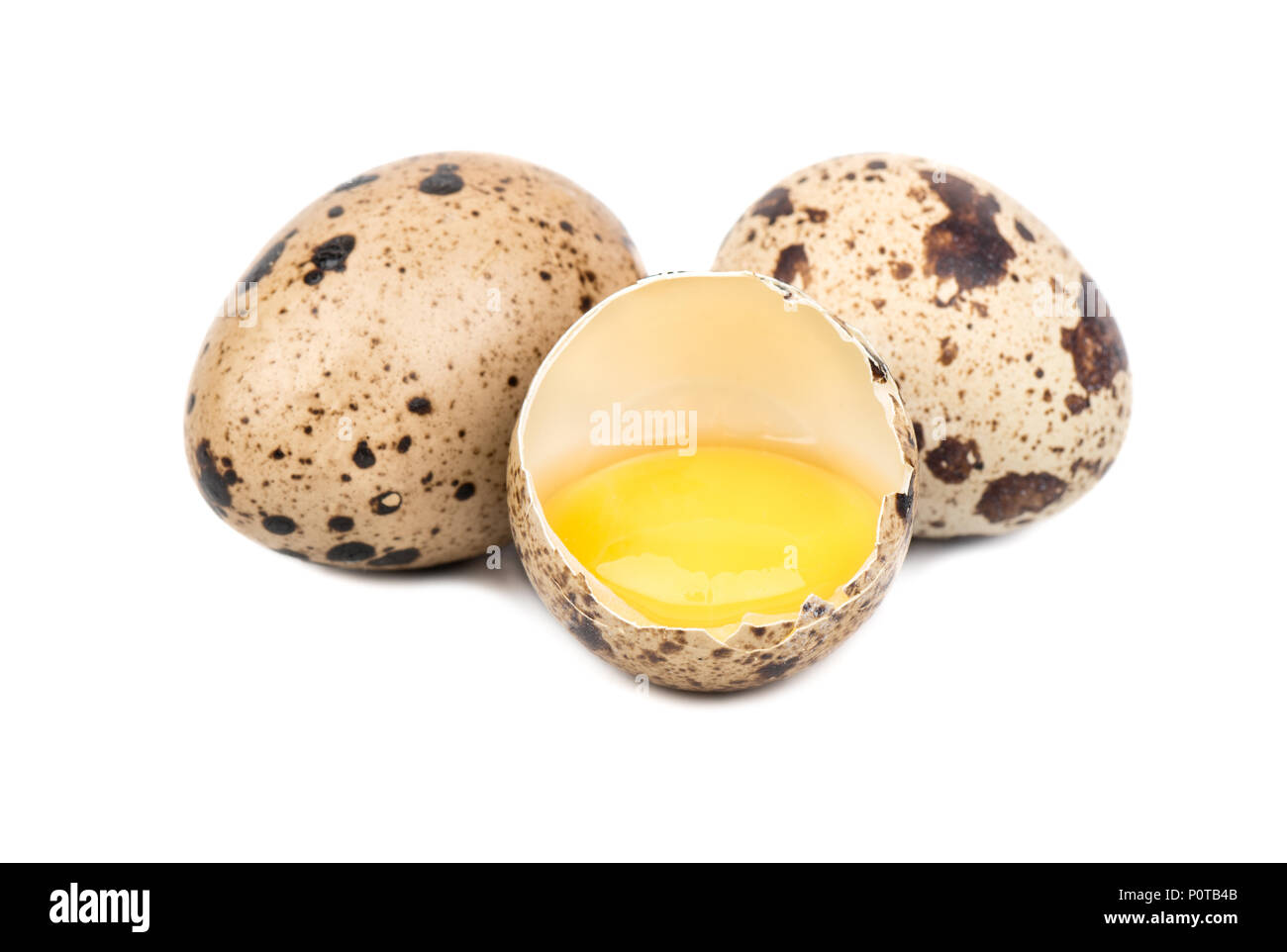 Broken raw quail egg on white background Stock Photo - Alamy