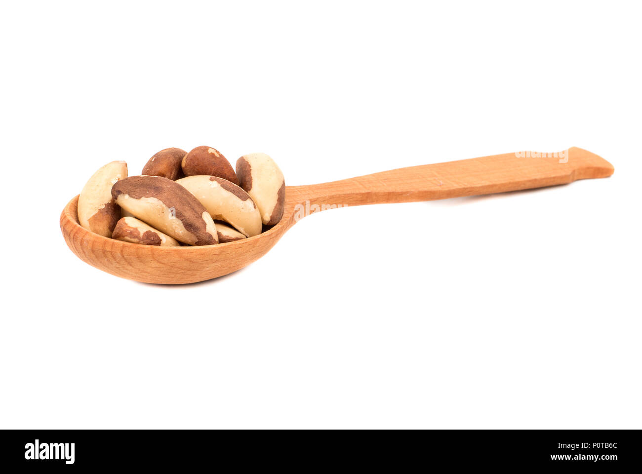 Brazil nuts in wooden spoon on white background Stock Photo - Alamy