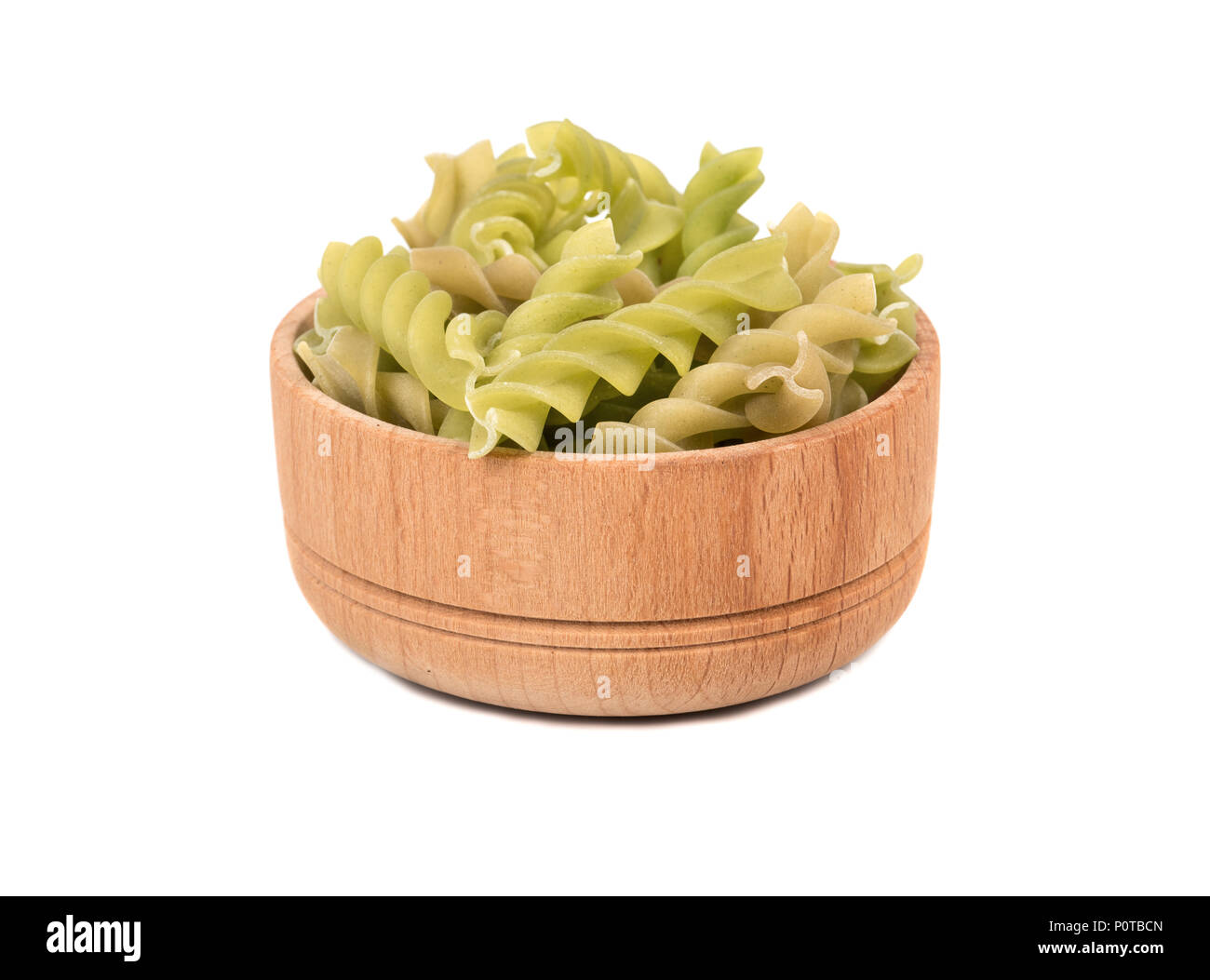 Green pasta fusilli in a small bowl on a white background Stock Photo ...