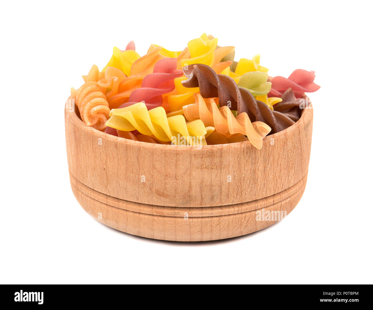 Colored pasta fusilli in a wooden bowl on white background Stock Photo ...