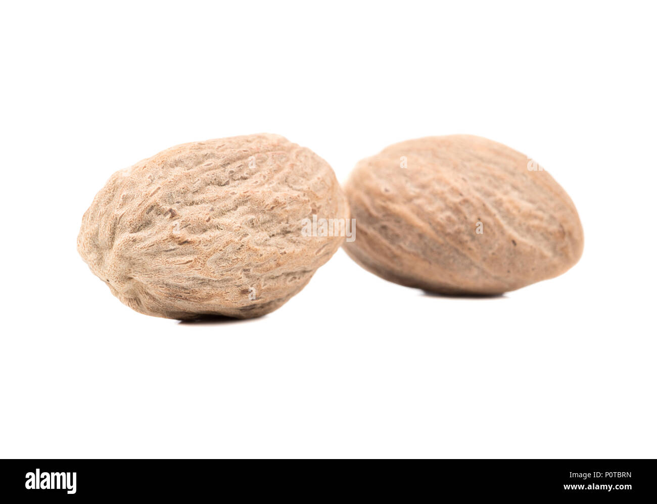 Two dry whole nutmeg isolated on white background Stock Photo - Alamy