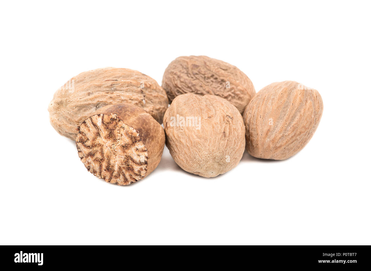 Dry nutmeg with half isolated on white background Stock Photo - Alamy