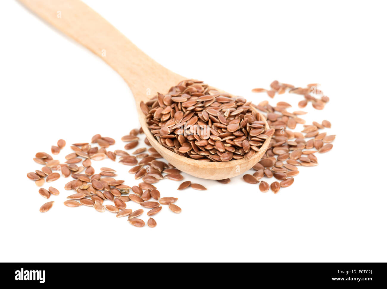Flax seeds in the spoon and scattered beans on a white background Stock ...