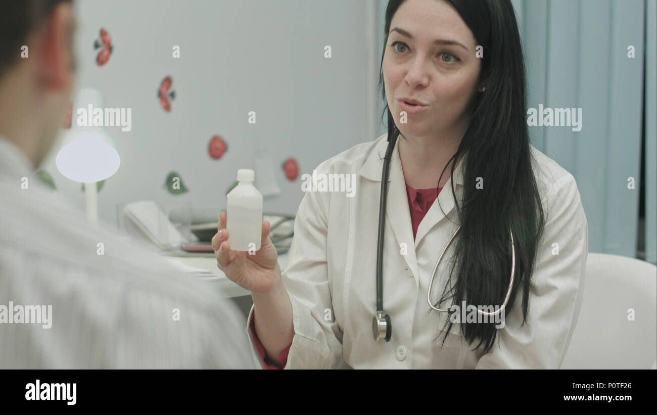 Smiling female doctor recommending drugs hi-res stock photography and ...