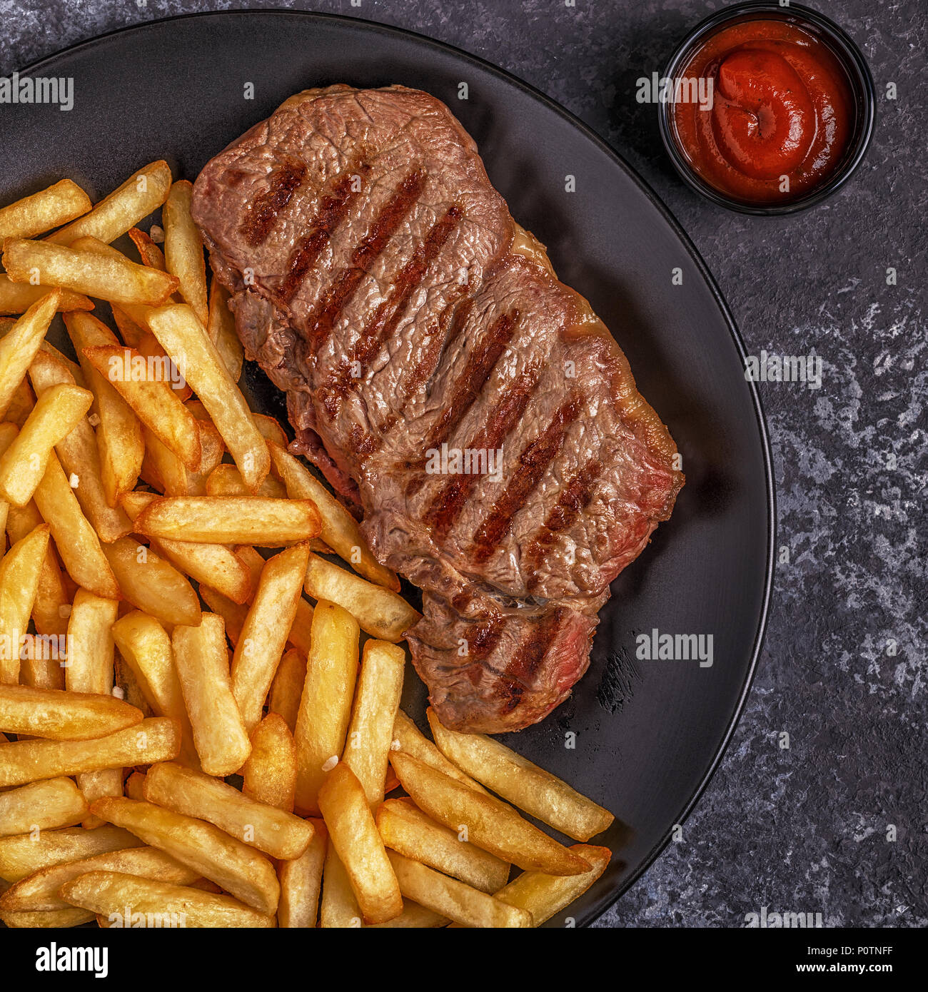 Beef barbecue steak with french fries, top view Stock Photo - Alamy