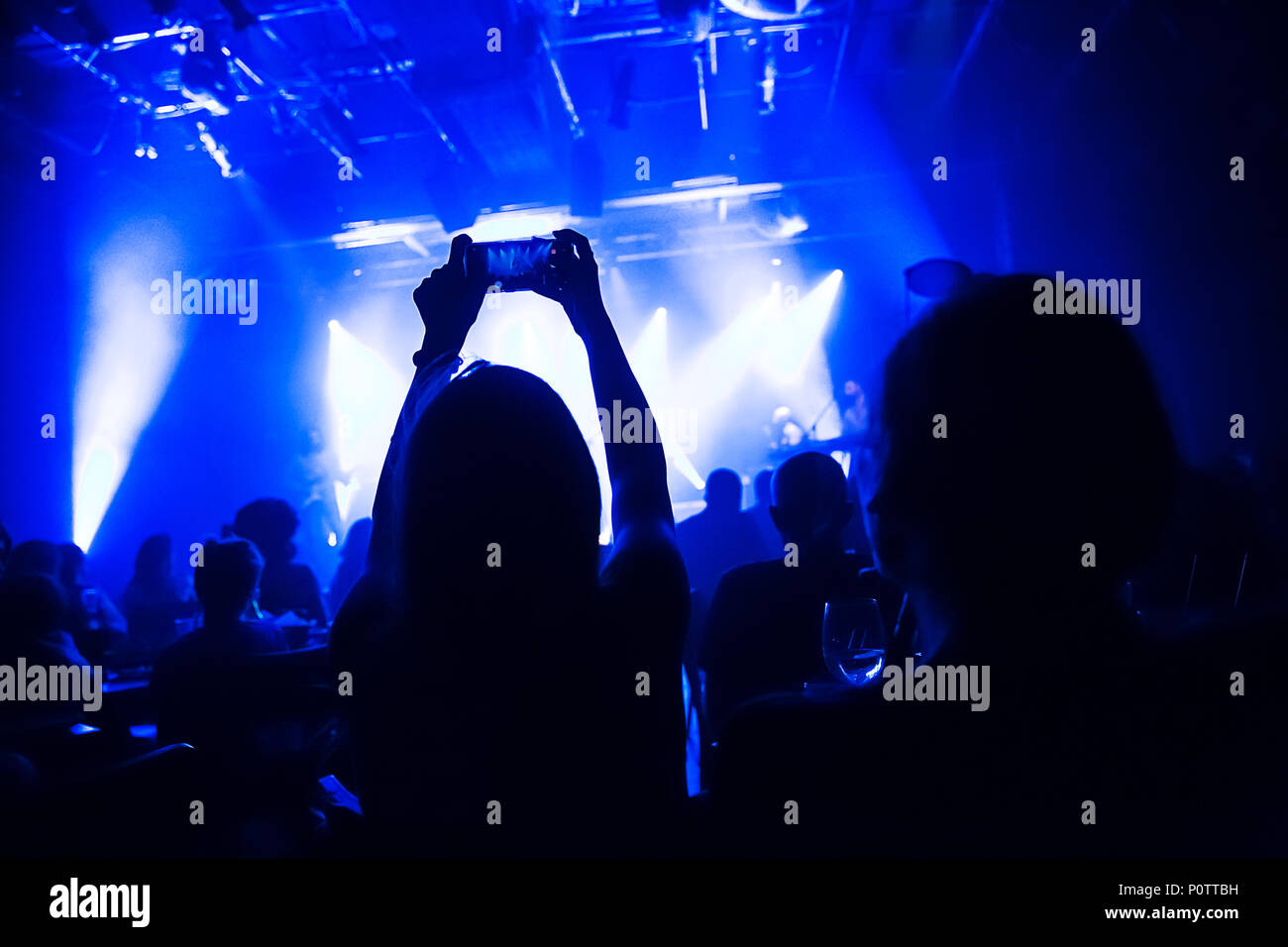 Crowd at concert and blurred stage lights . Close up of photographing ...