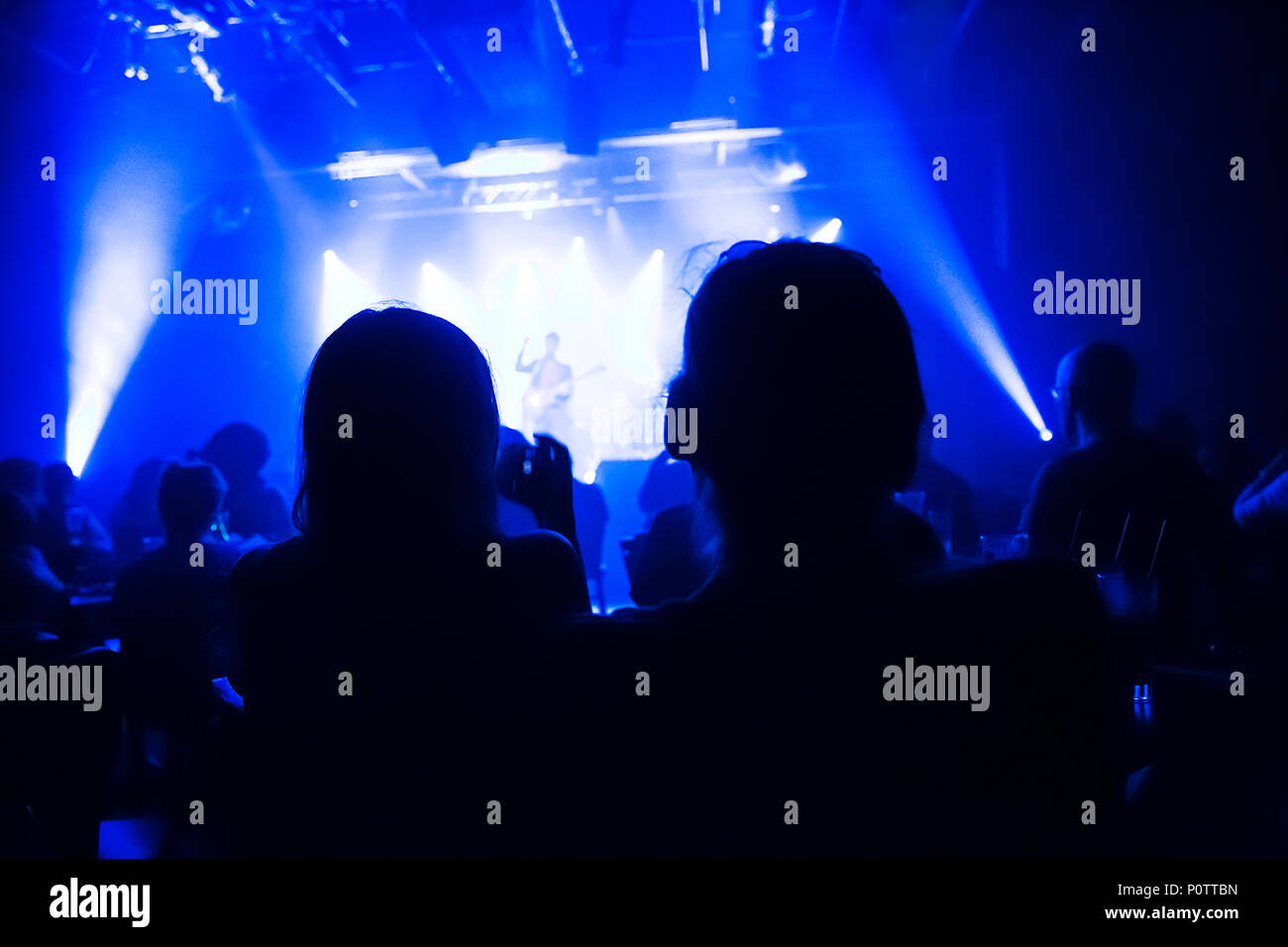 Crowd at concert and blurred stage lights . Close up of photographing ...