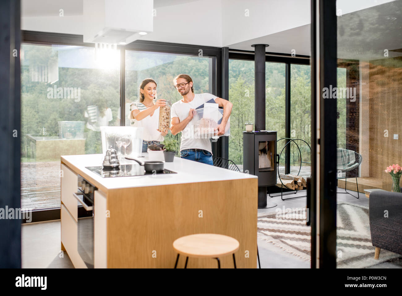 Couple making order in their new modern house Stock Photo - Alamy