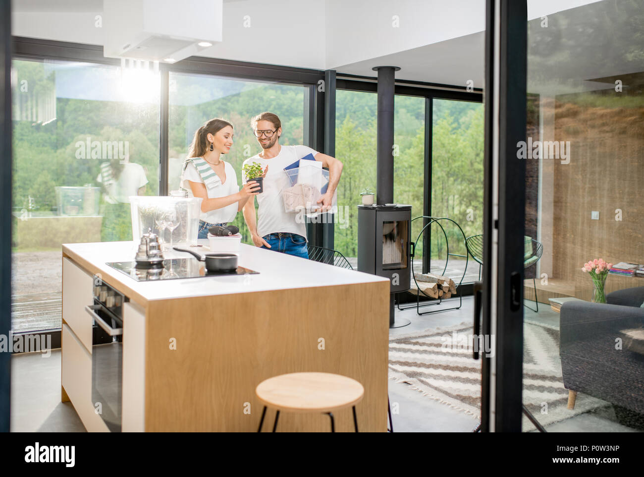 Couple making order in their new modern house Stock Photo - Alamy