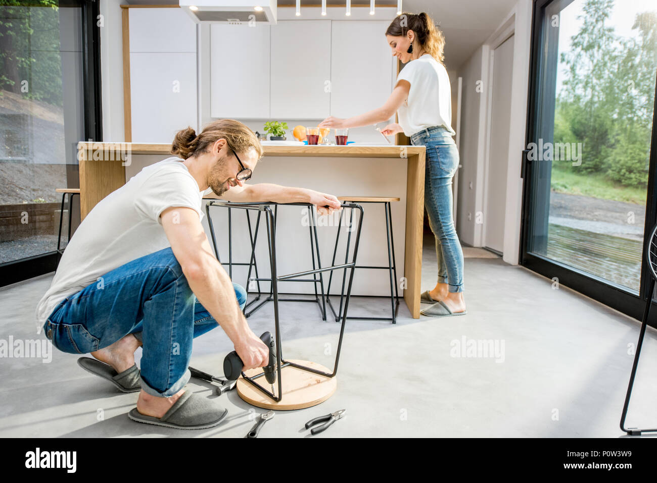 Couple doing house chores at the modern apartment Stock Photo - Alamy