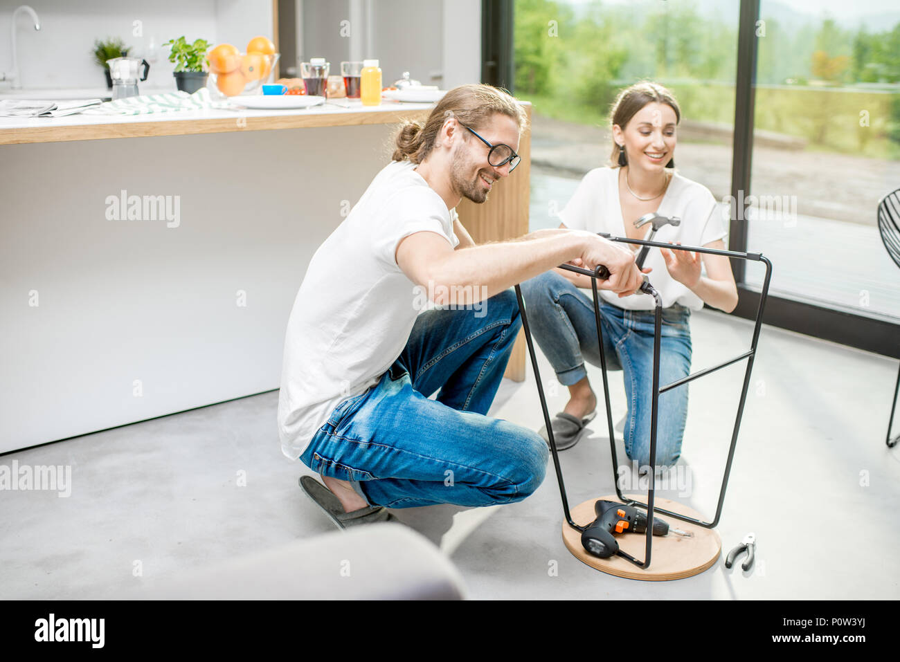 Couple doing house chores at the modern apartment Stock Photo - Alamy